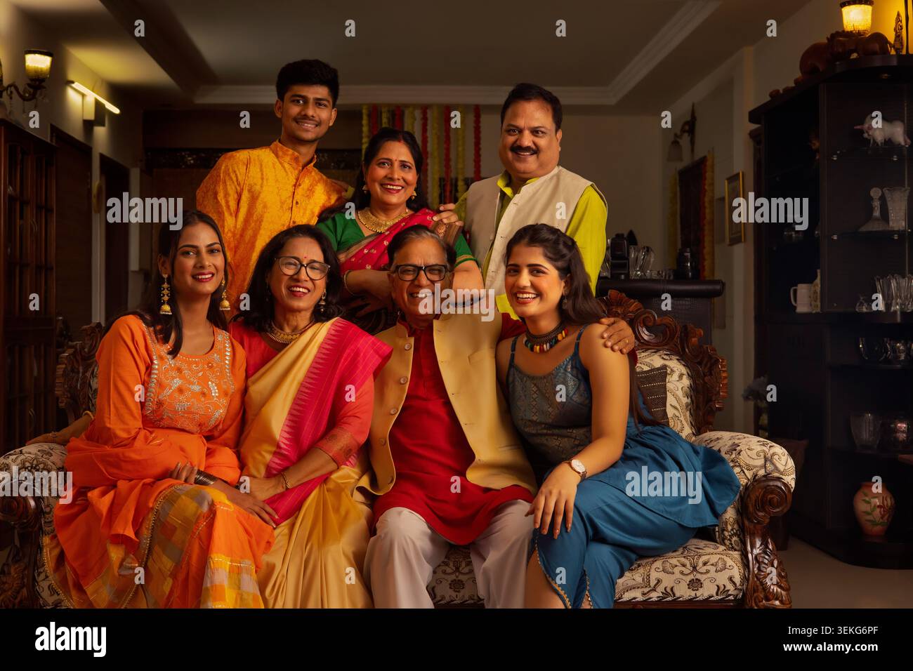Portrait of happy Indian family in traditional outfit together at home ...