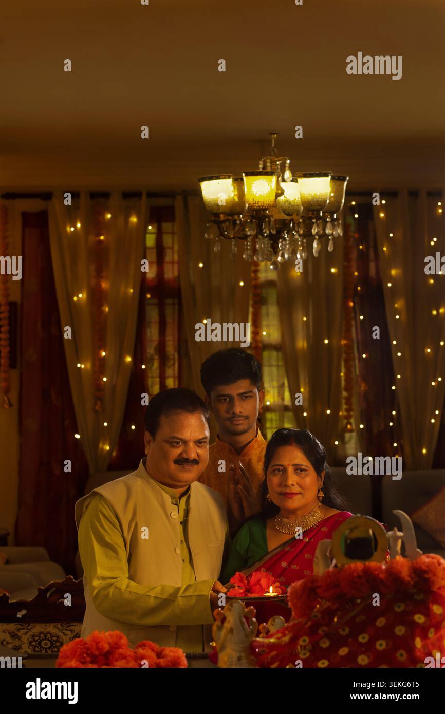 Middle-aged couple with their son worshipping God together on the ...