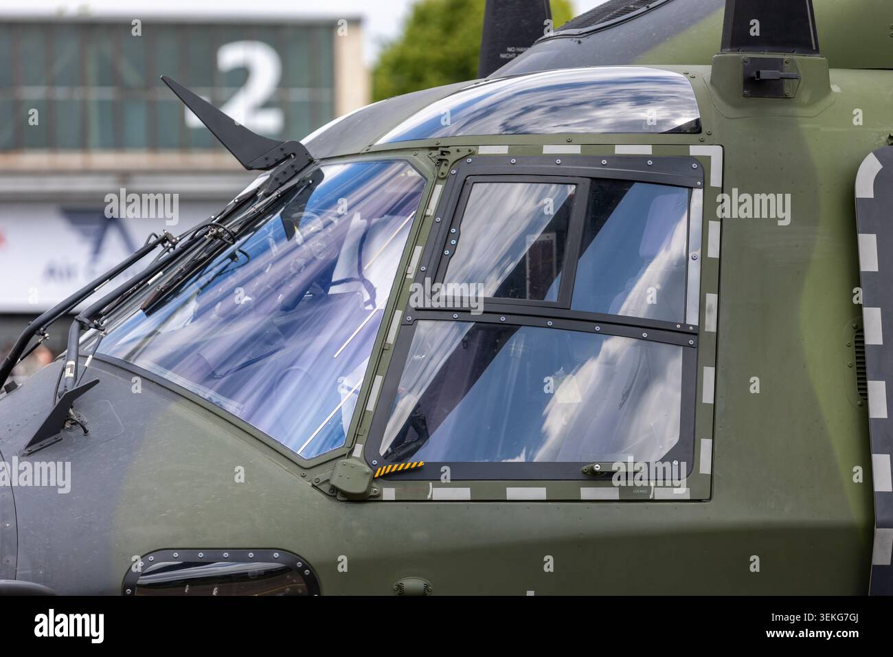 Closeup of military helicopter cockpit reflective windshield camouflage ...