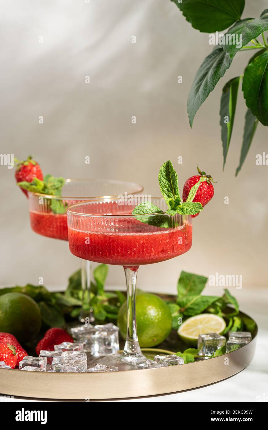 Refreshing frozen strawberry margaritas in elegant glasses, garnished ...