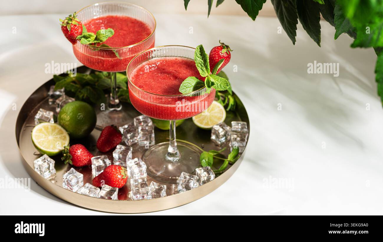 Refreshing frozen strawberry margaritas in elegant glasses, garnished ...