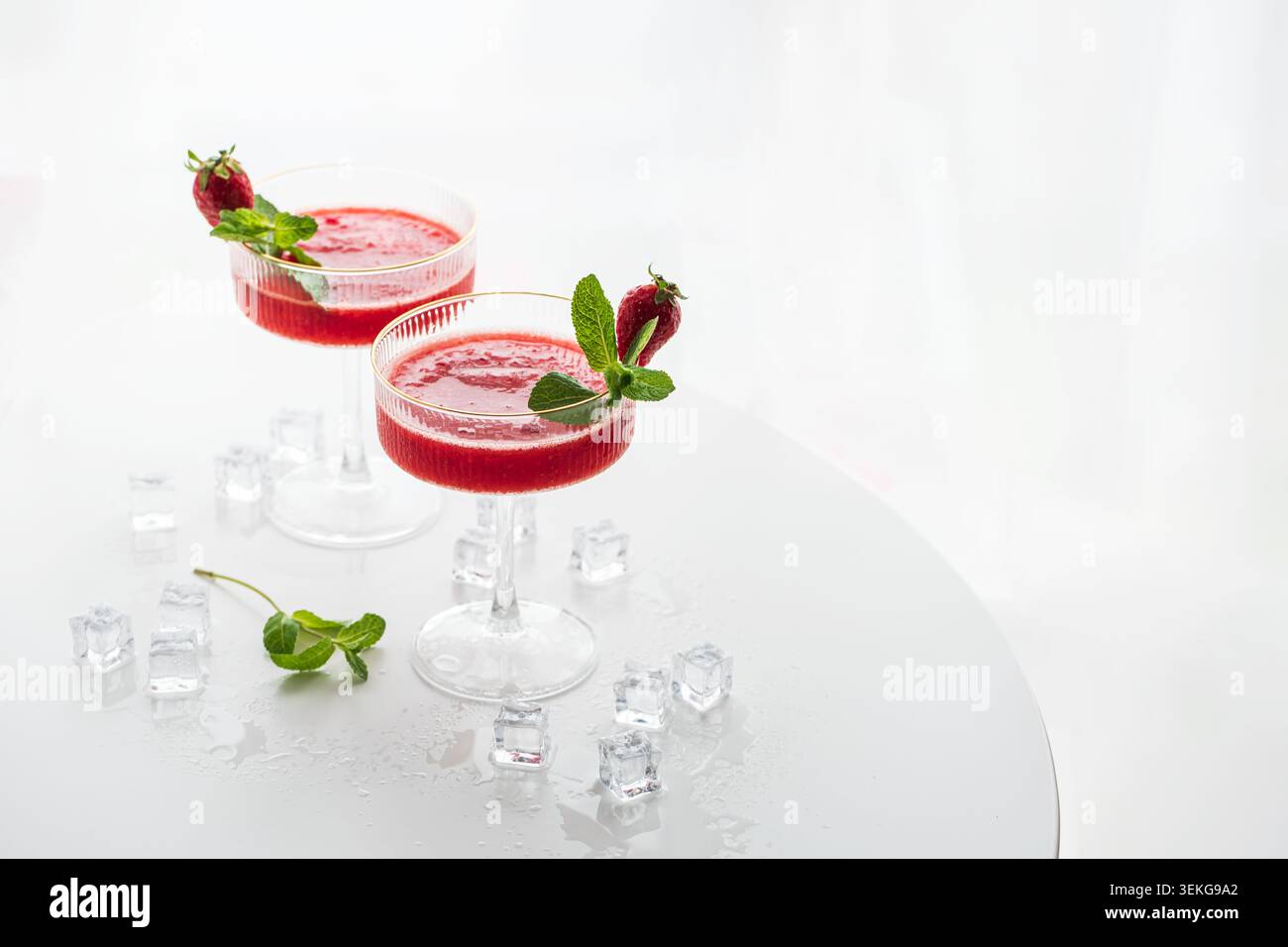 Strawberry margarita cocktails with fresh mint and whole strawberry ...