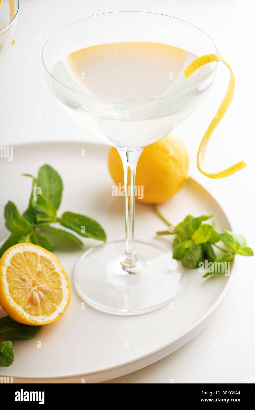 French 75 cocktails shimmering in coupe glass with a lemon twist ...