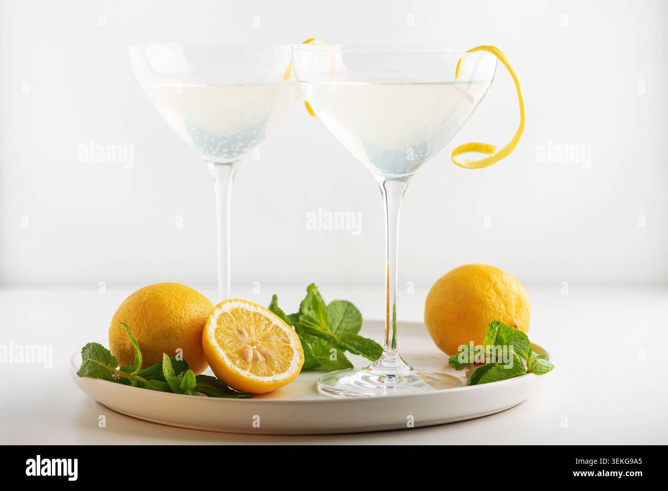 French 75 cocktails shimmering in coupe glass with a lemon twist ...