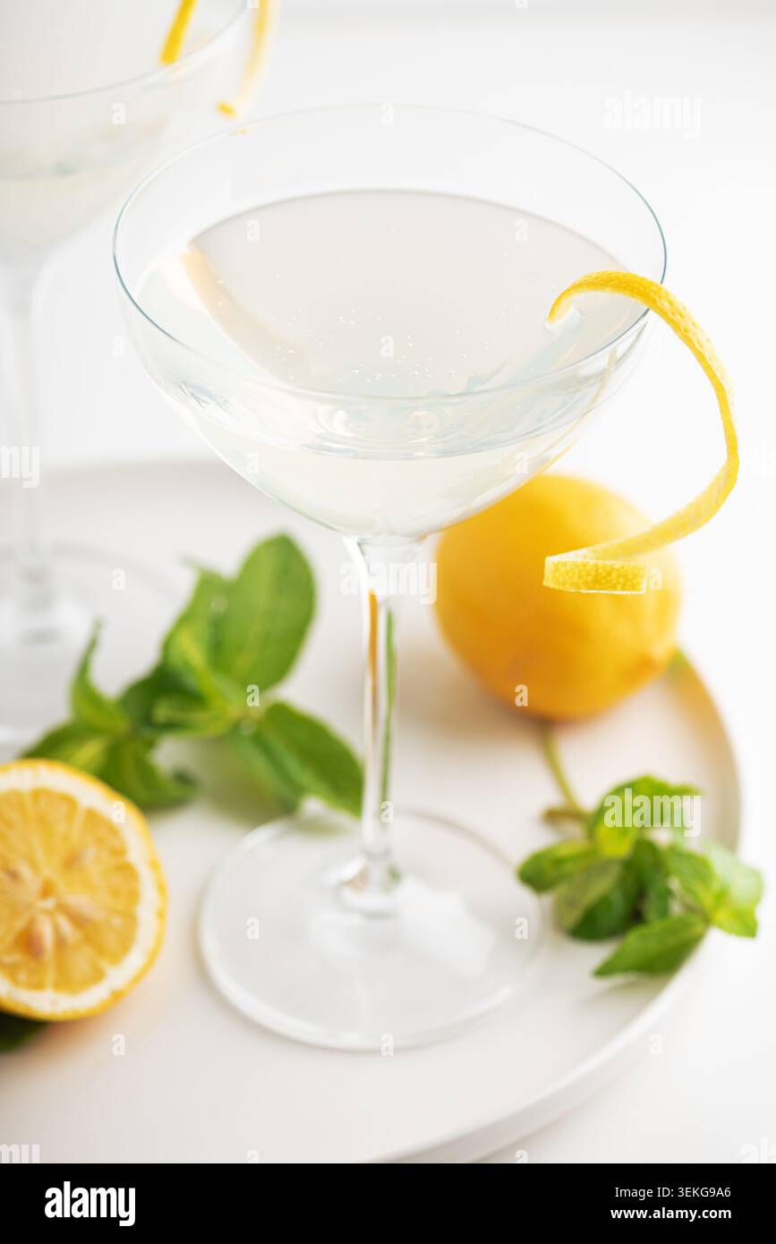 French 75 cocktails shimmering in coupe glass with a lemon twist ...