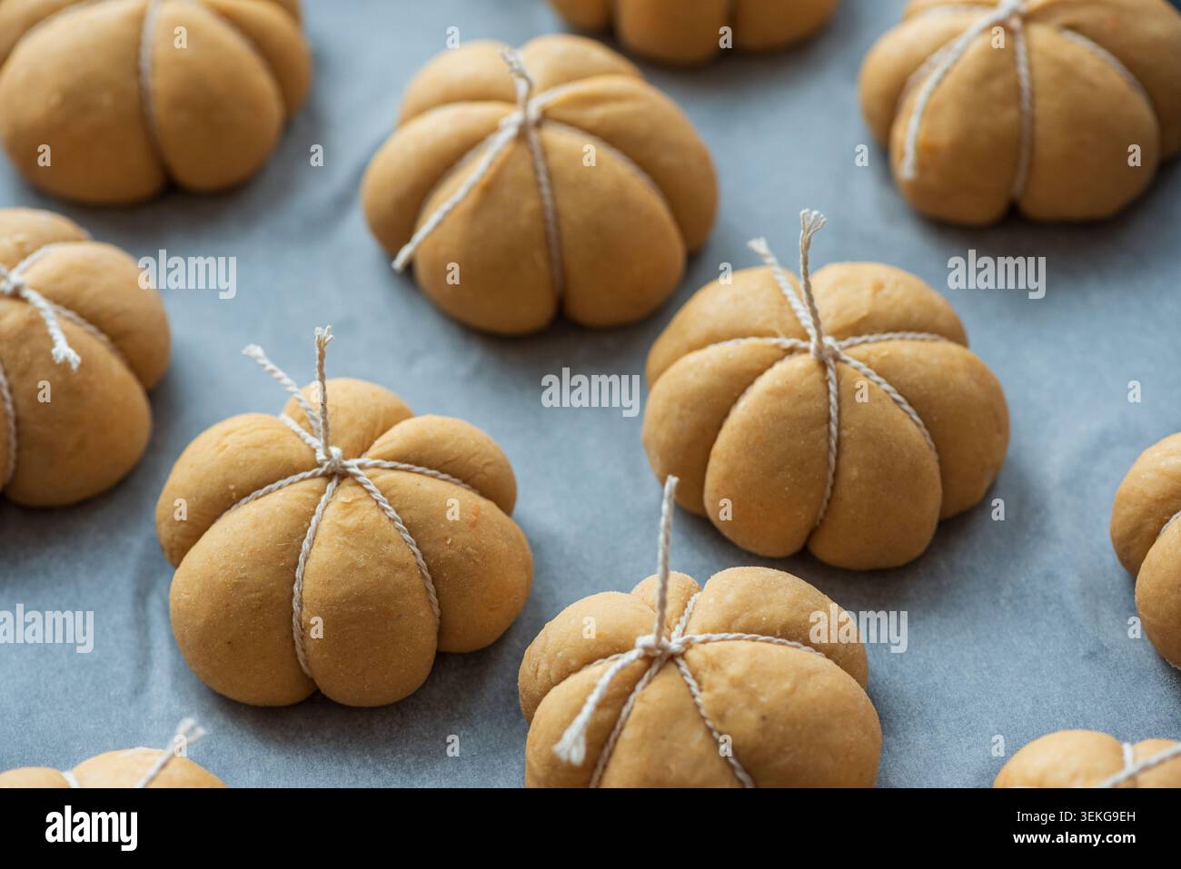 Pumpkin spice bread buns, shaped like small pumpkins and tied with ...