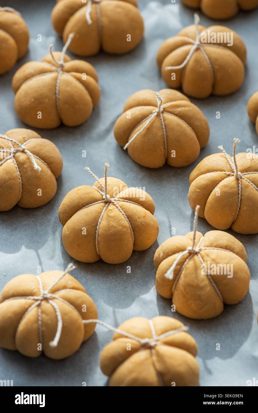 Pumpkin spice bread buns, shaped like small pumpkins and tied with ...