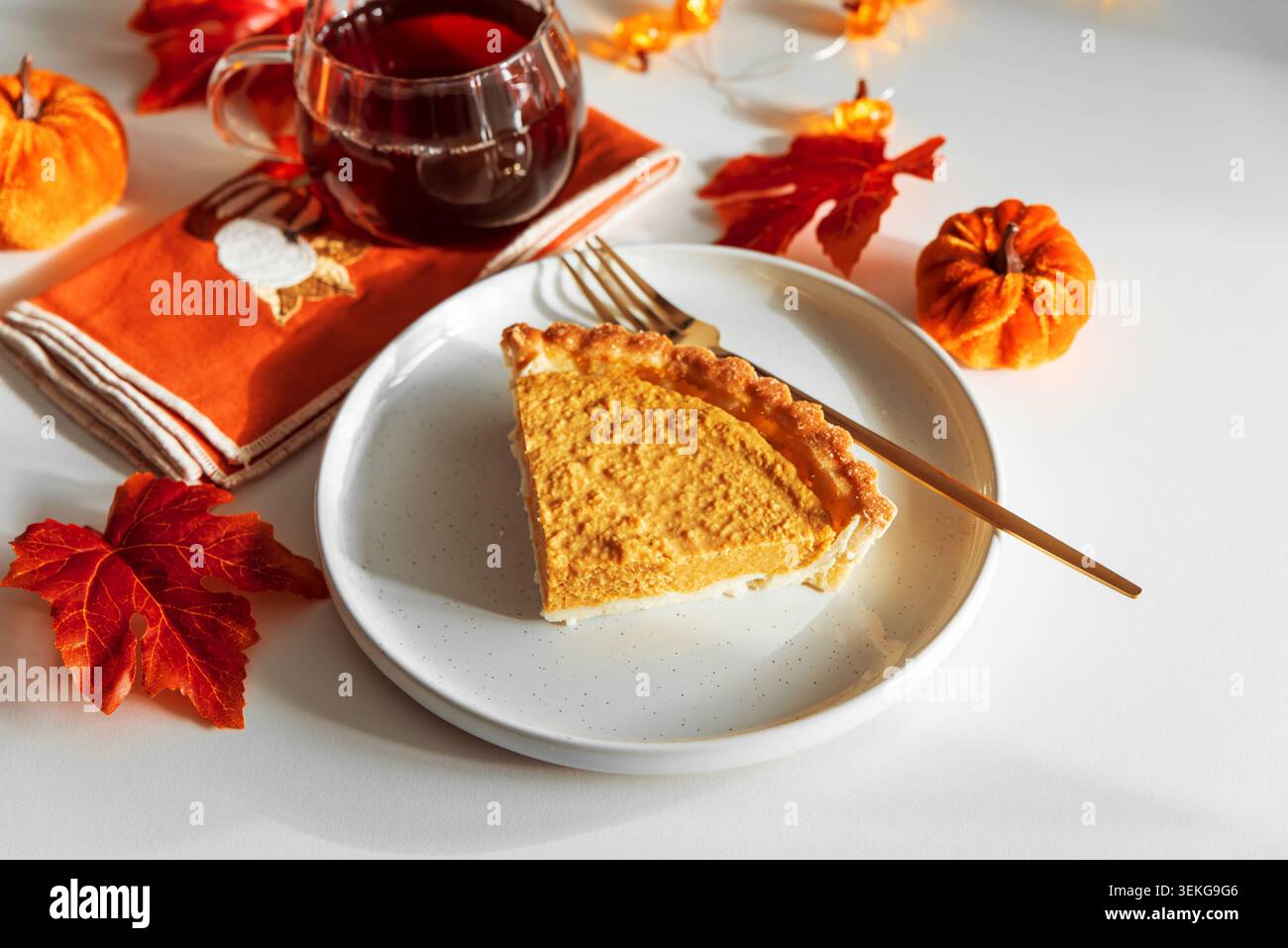 Pumpkin Pie Slice with Autumn Drink and Festive Table Decor Stock Photo ...