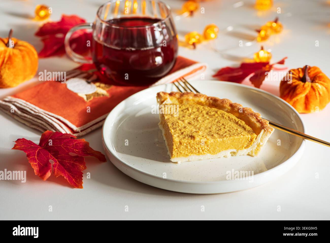 Pumpkin Pie Slice with Autumn Drink and Festive Table Decor Stock Photo ...