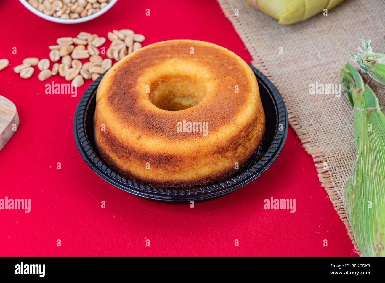 Close-up shot featuring a cornbread cake atop a black plate, presented ...