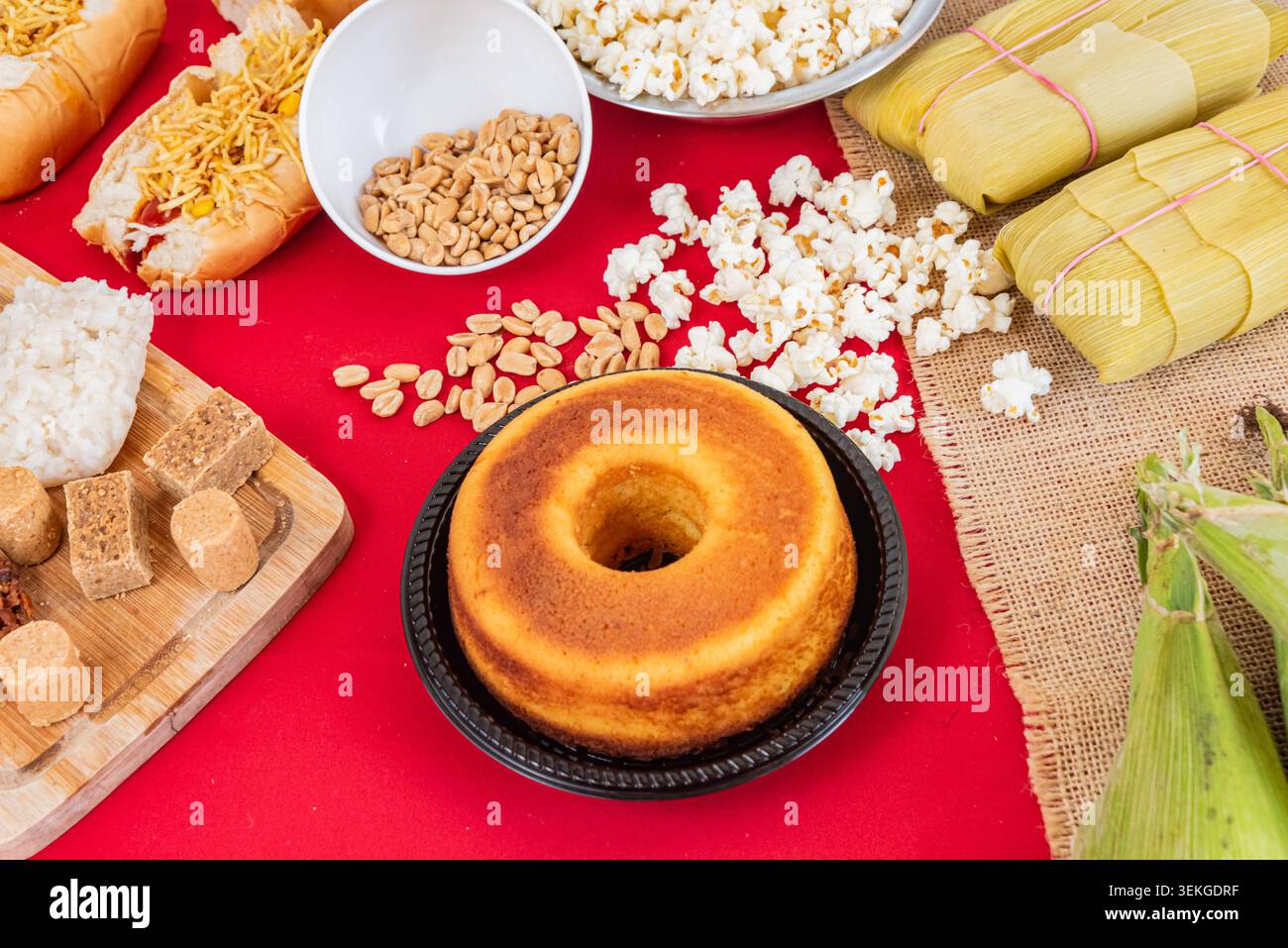 Overhead shot displaying festa junina food arrangement on vibrant red ...