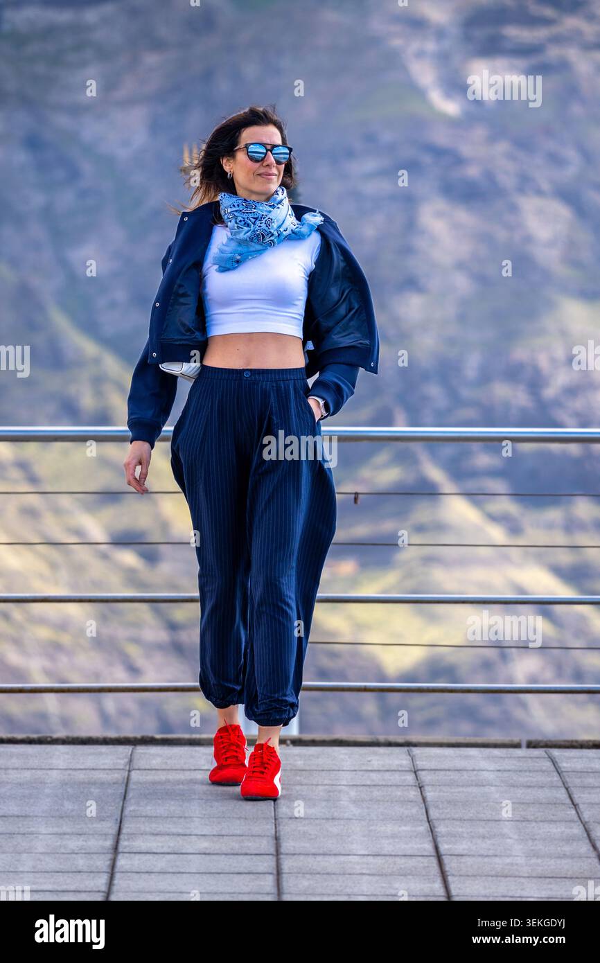 Young Caucasian Woman in Navy Jacket and Red Sneakers on Agaete Port ...