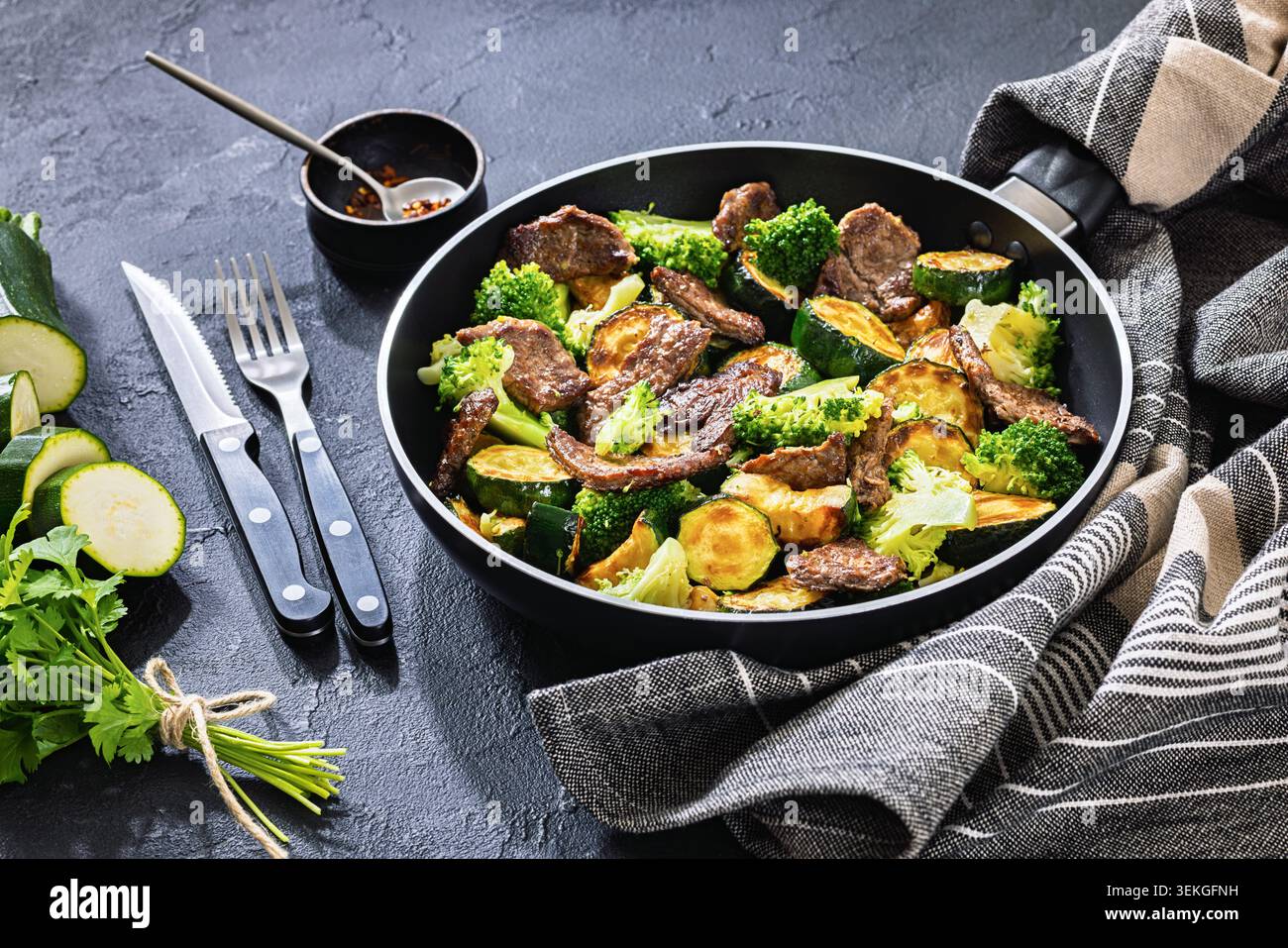 Beef and Broccoli Stir Fry with Zucchini in a black skillet, perfectly ...