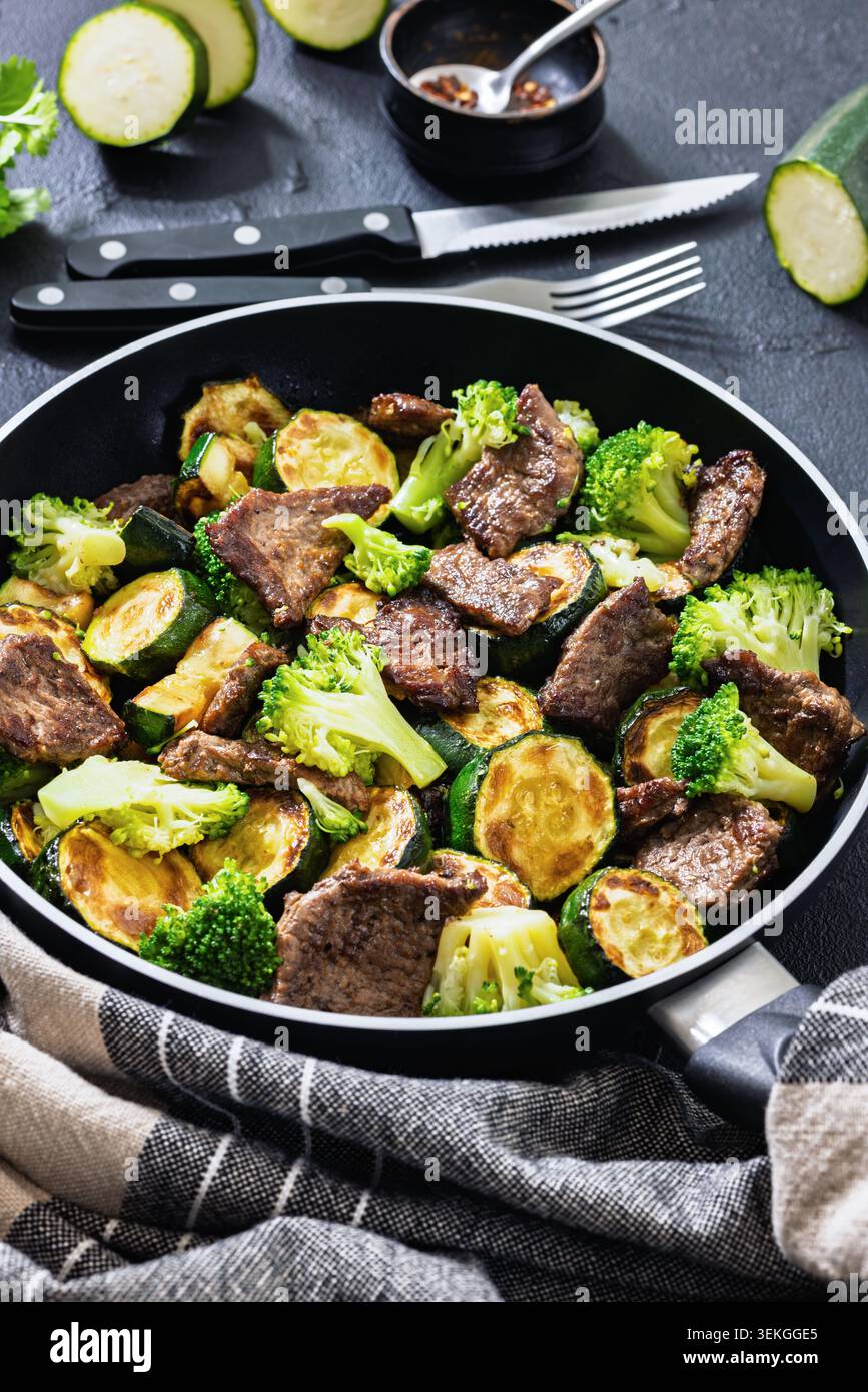 Chinese Beef and Broccoli Skillet served on a dark textured background ...