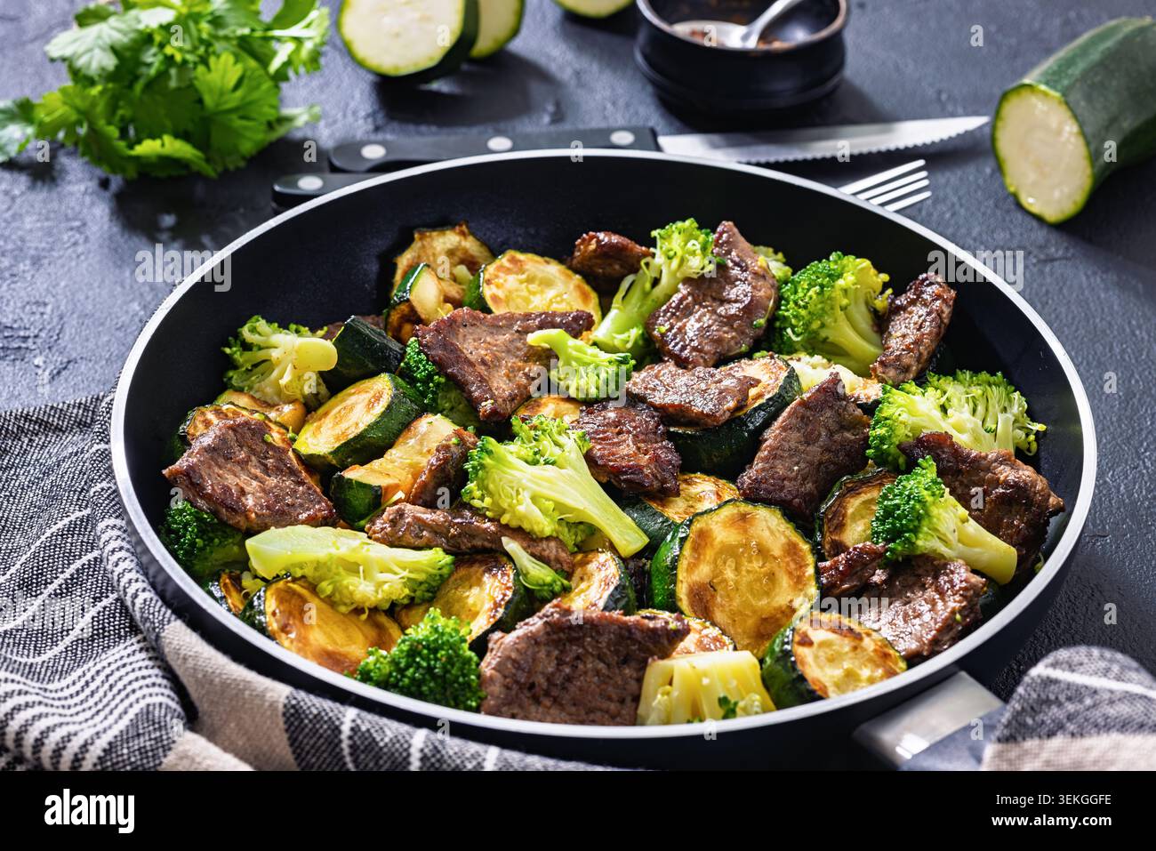 Chinese Beef and Broccoli Skillet served on a dark textured background ...