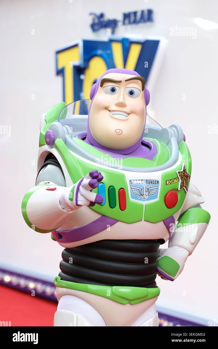 A person costumed as Buzz Lightyear poses for photographers upon ...
