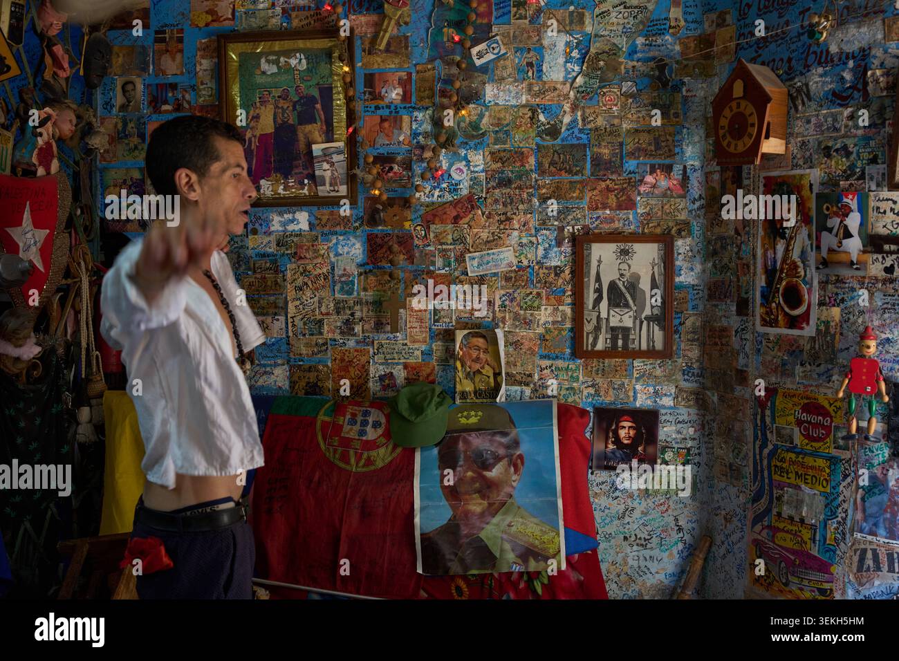 A souvenir shop worker gestures next to images of Raul Castro, Che ...