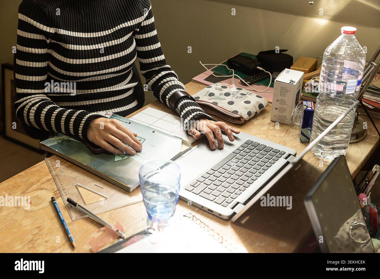 a teenager doing her homework at home after school, in Sint-Denijs ...