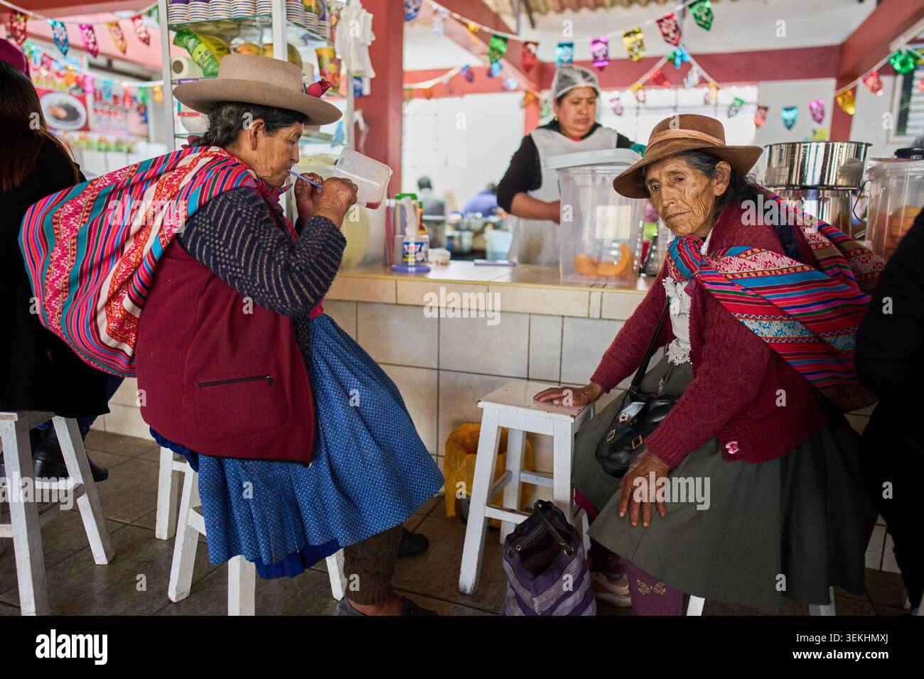 Susana Canua, left, and Lorenza Canua eat breakfast at a street market ...
