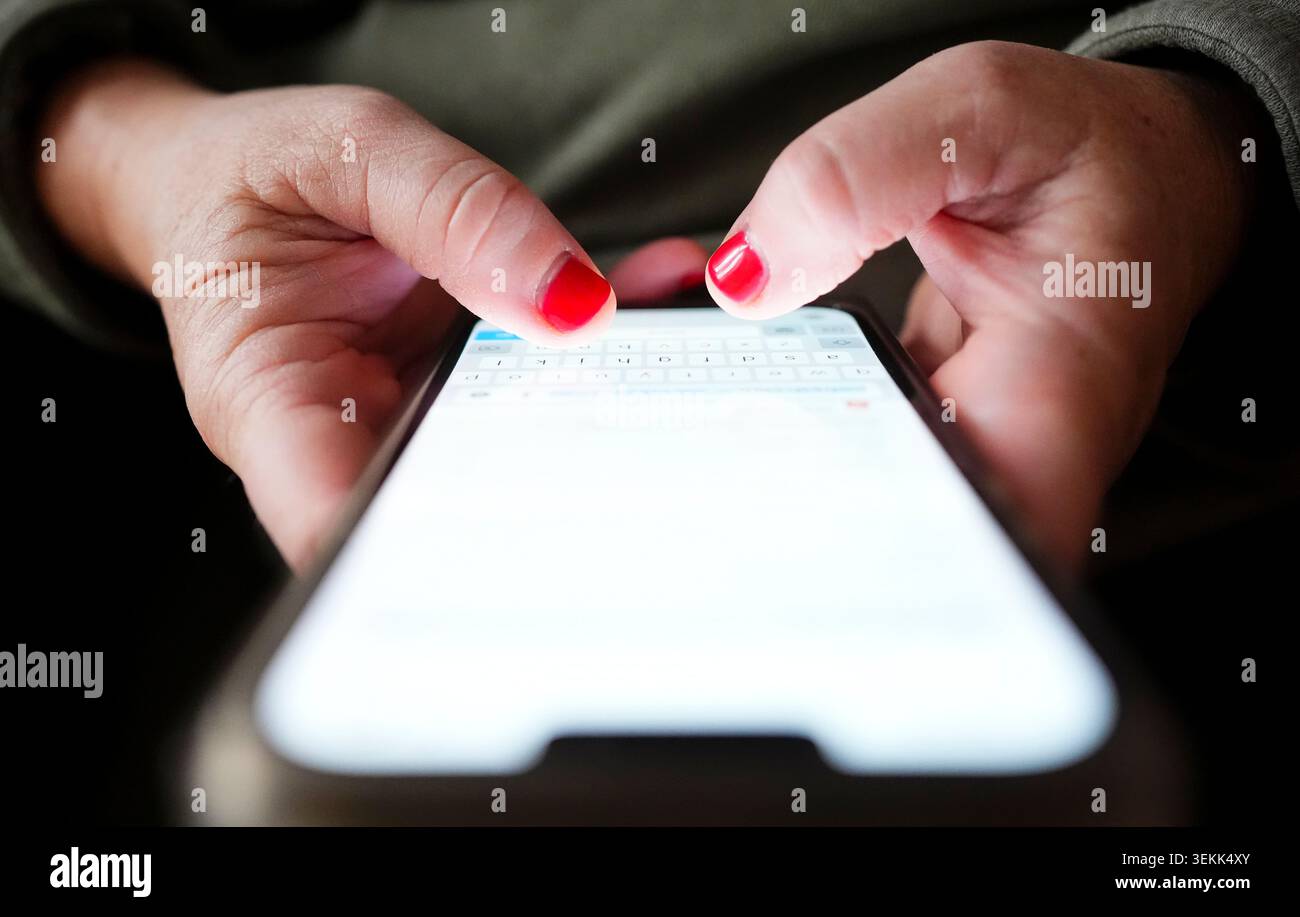 A person types on a cellphone in Ottawa on, Dec. 15, 2025. THE CANADIAN ...