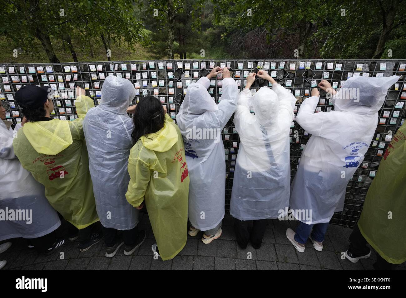 Korean adoptees put their nametags with South Korean volunteers on The ...