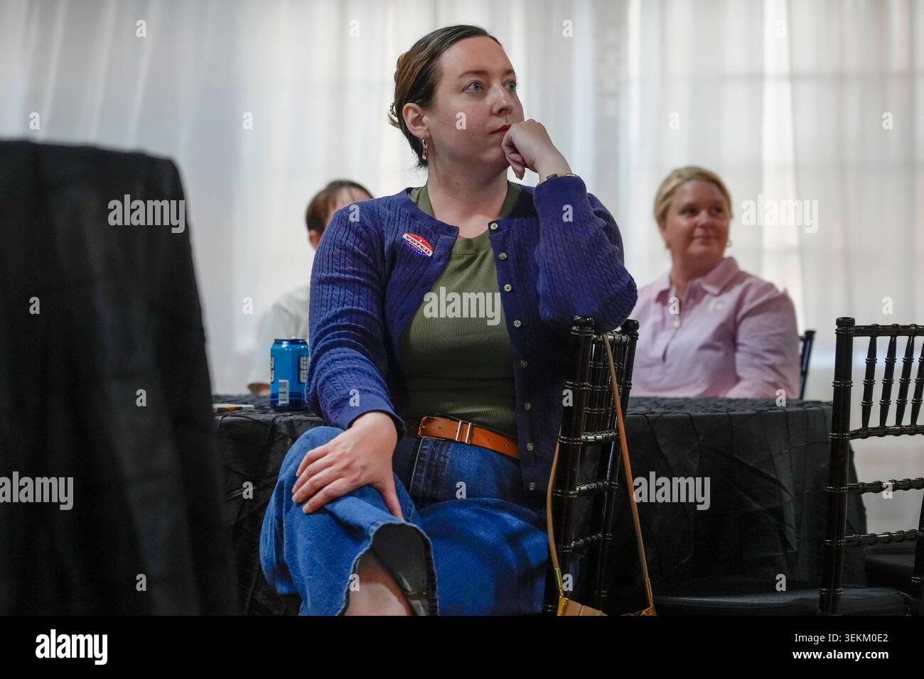 Courtney Blomme of Des Moines listens to a speech during an election ...