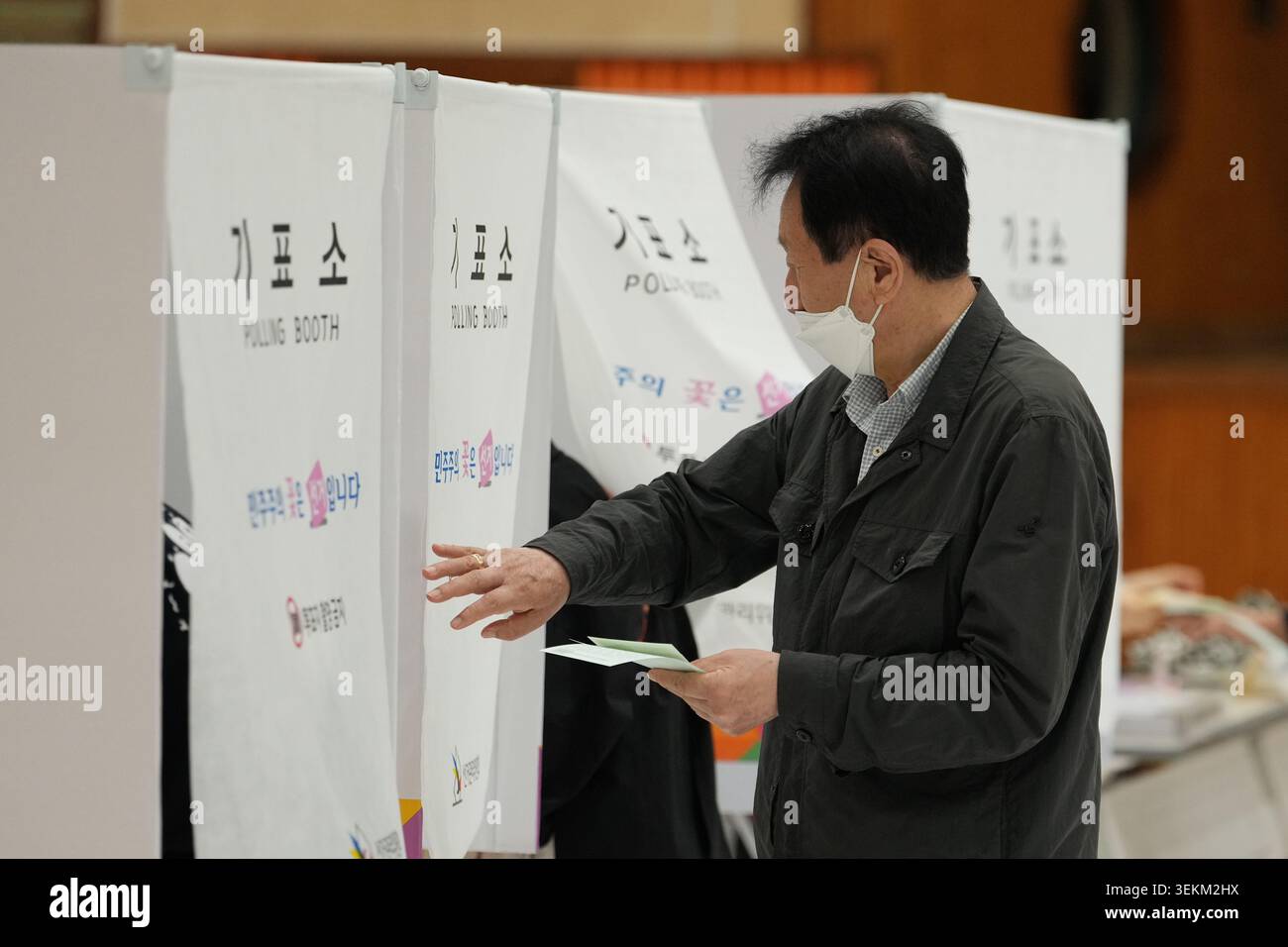 A voter arrives to cast his votes for the nationwide simultaneous local ...