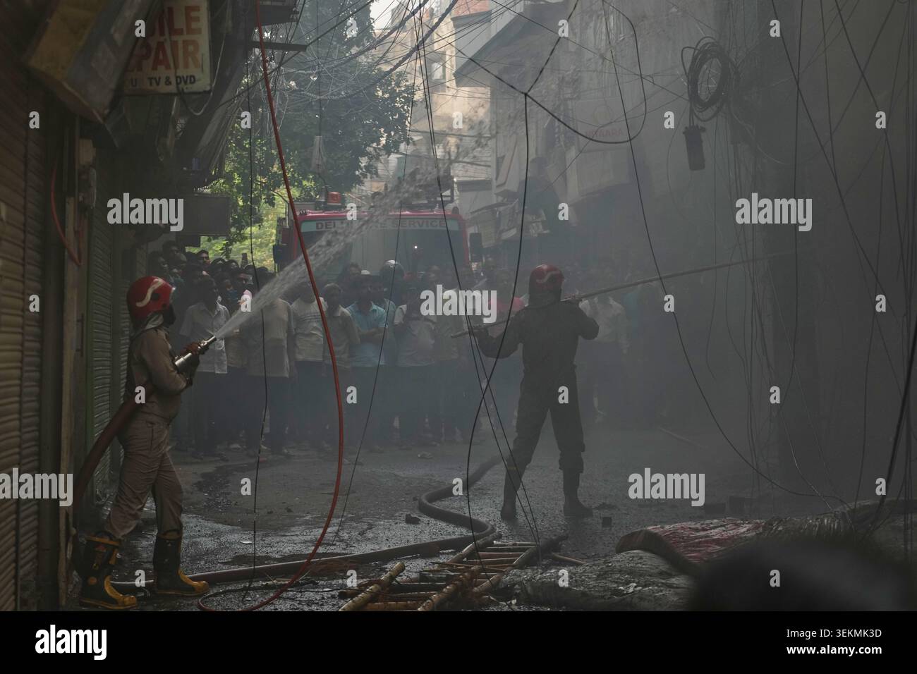 Firefighters douse a fire in a hotel in New Delhi, India, Wednesday ...