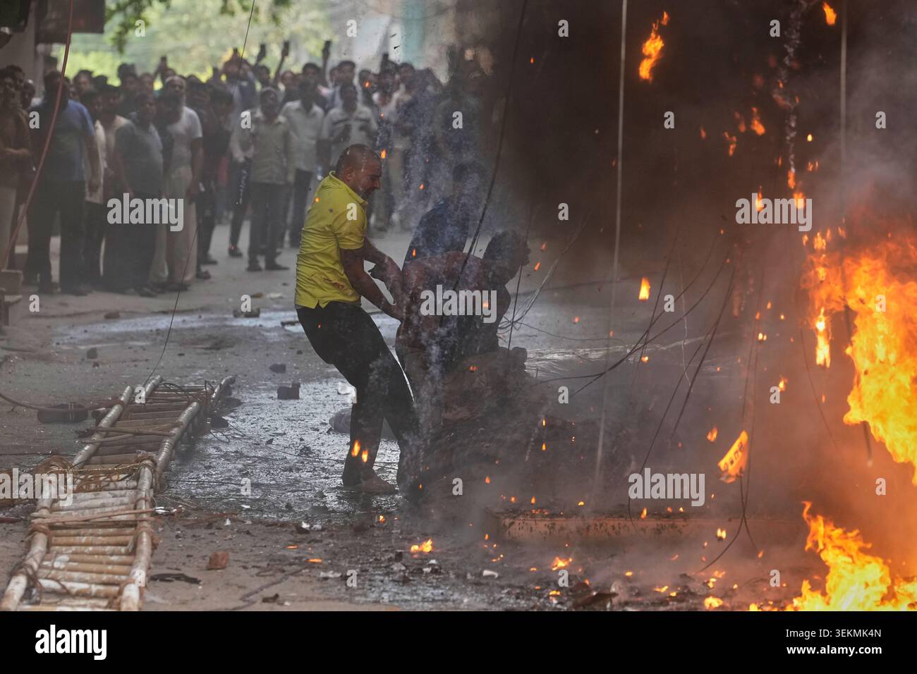 Local people rescue a foreign national from a hotel fire in New Delhi ...