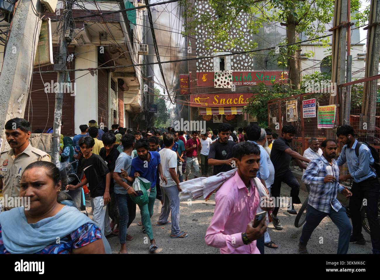 Locals and bystanders run for cover as a hotel fire spreads following ...