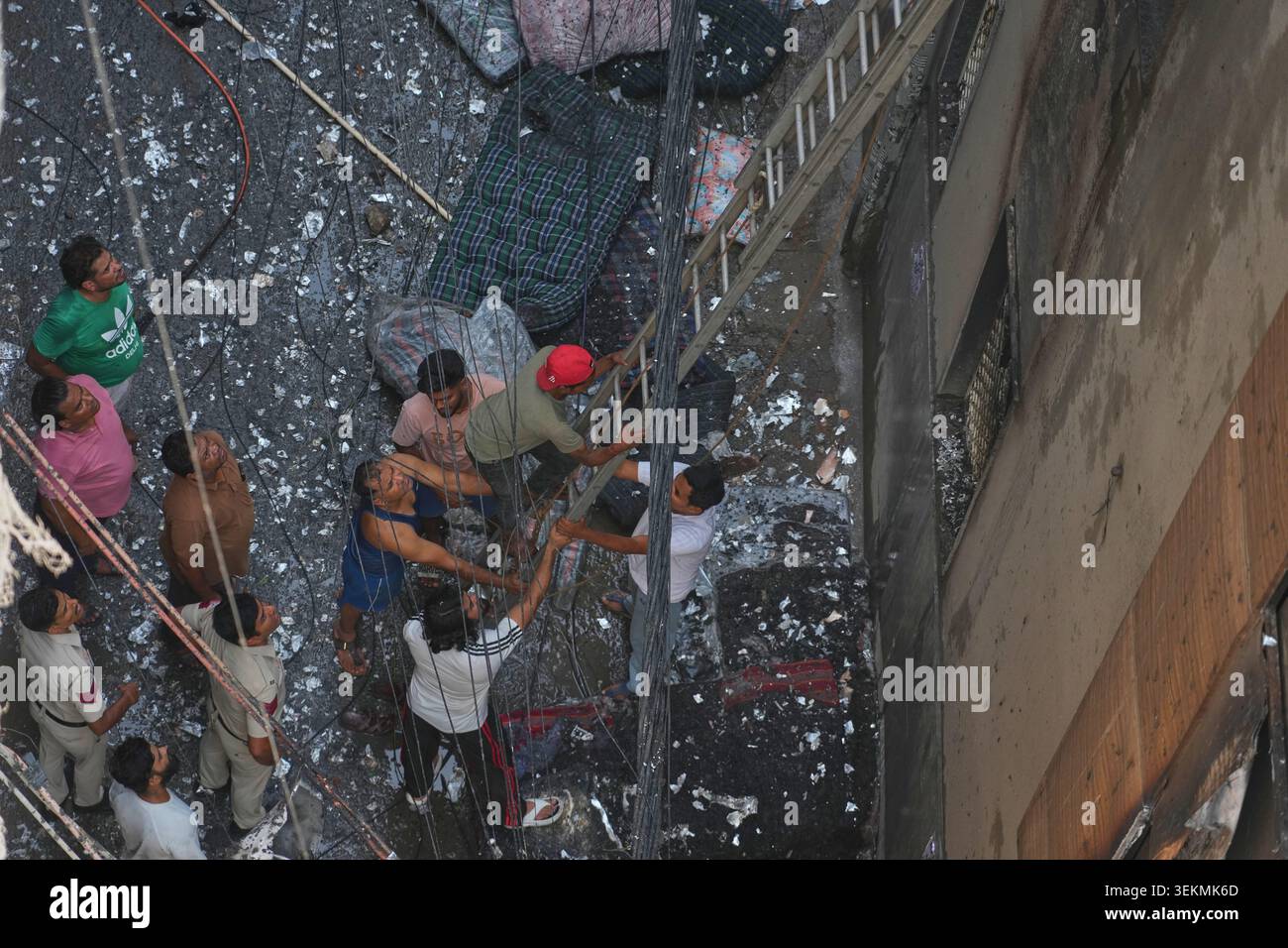 Firefighters and locals help in rescue effort of trapped people in a ...
