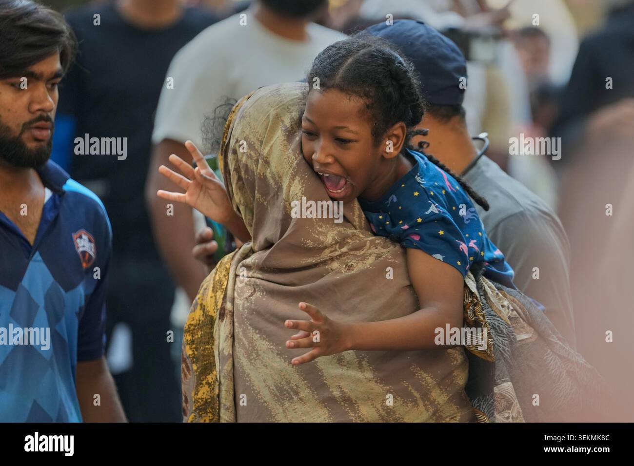 A girl reacts after being rescued from a hotel fire in New Delhi, India ...