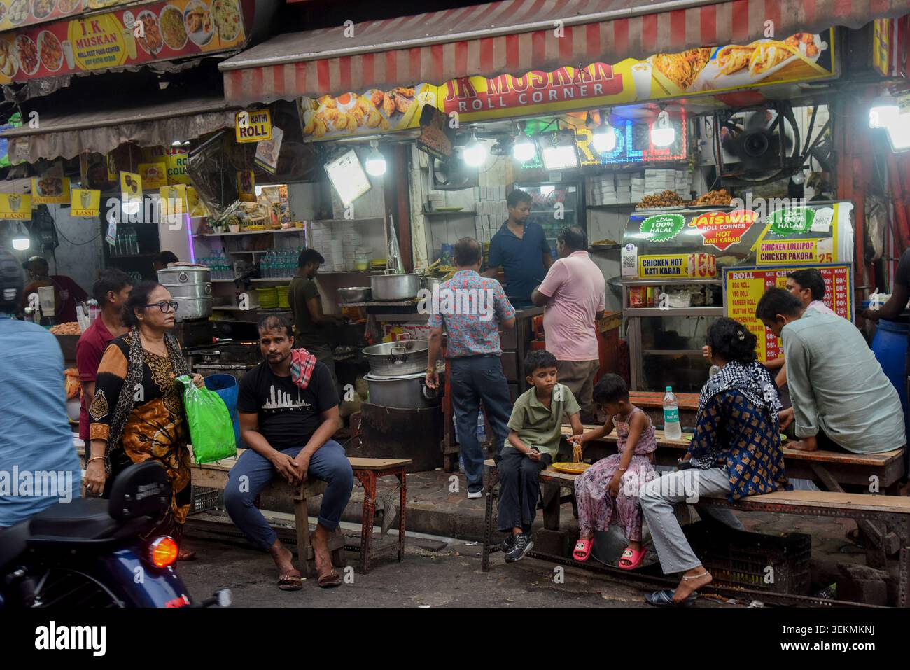 People eat food at a roadside stall in Kolkata, India, on June 2, 2026 ...