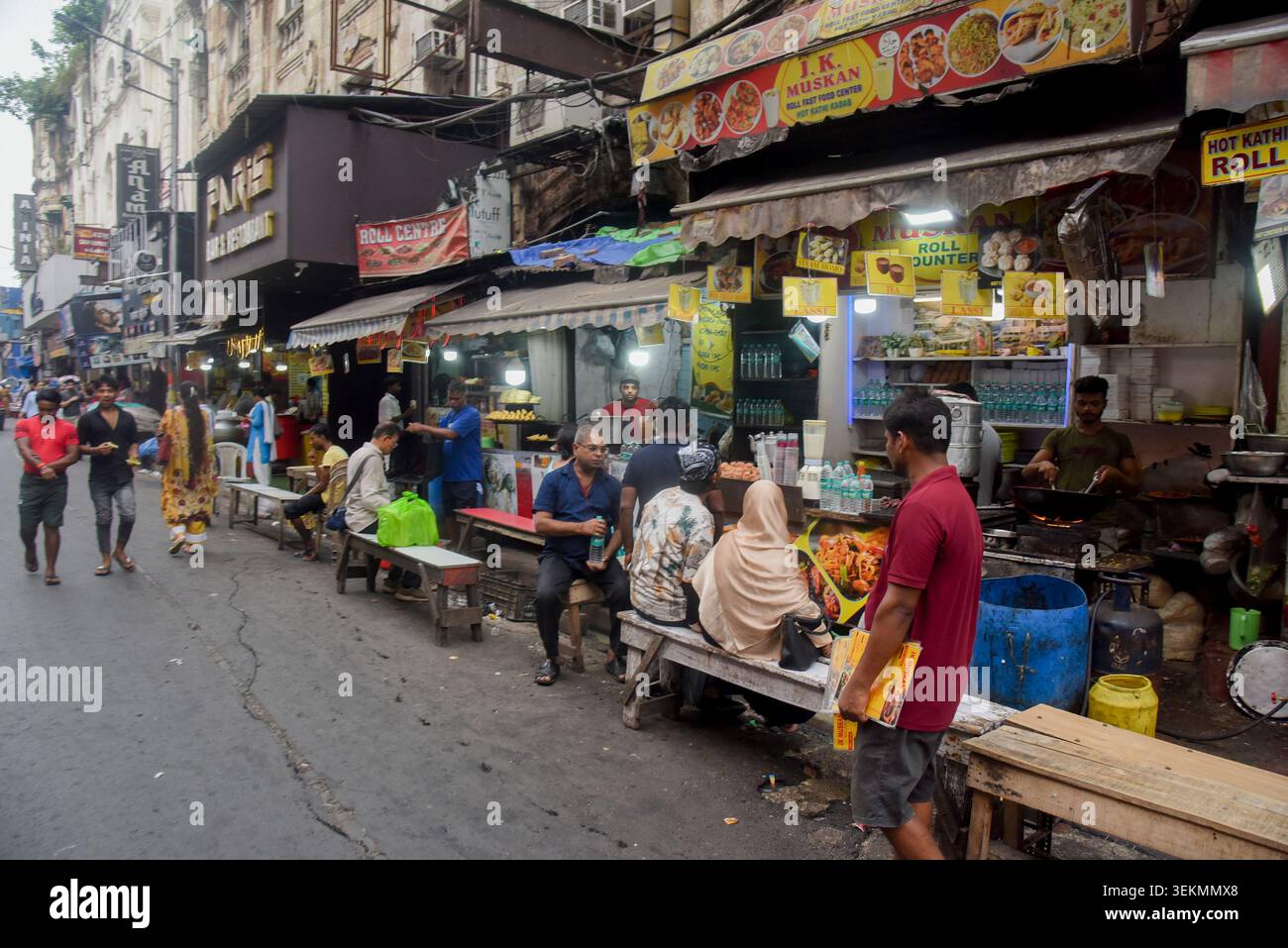 People eat food at a roadside stall in Kolkata, India, on June 2, 2026 ...