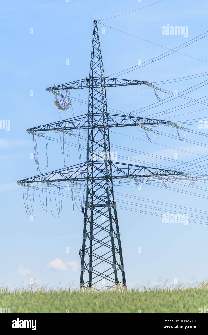 enns, austria, 02 june 2026, construction workers on a high voltage ...