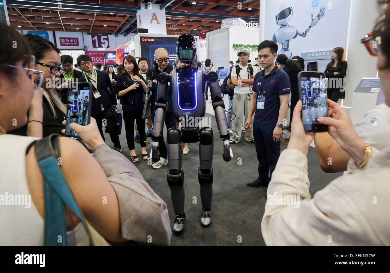 People take photos to a robot of VinRobotics at the Computex Taipei ...