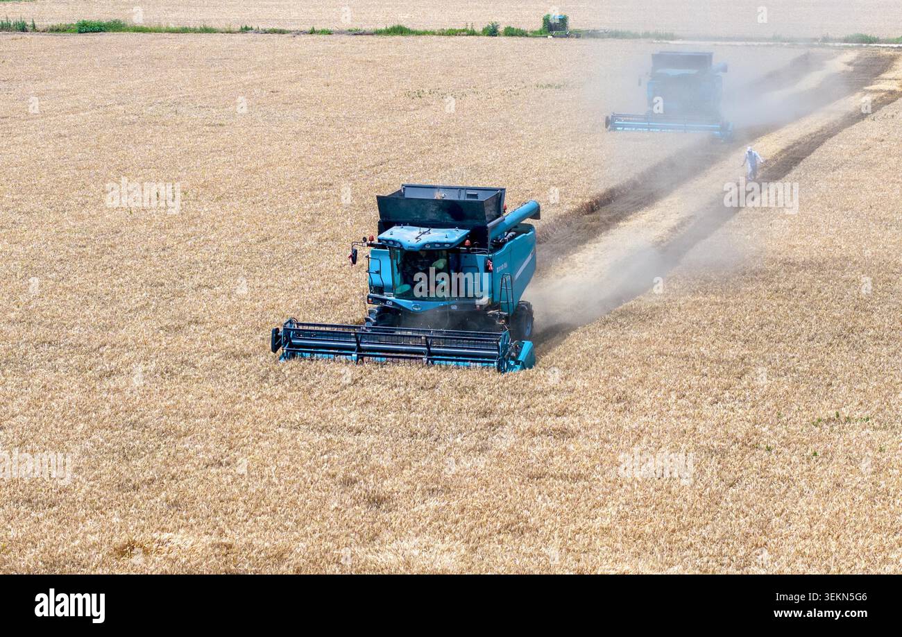 A harvester works in a wheat field in Zhuge Town, Yibin District ...