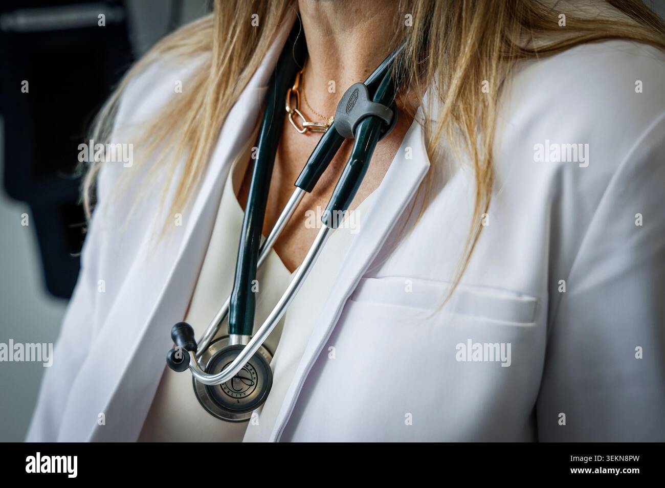A doctor wears a lab coat and stethoscope in an exam room on Friday ...
