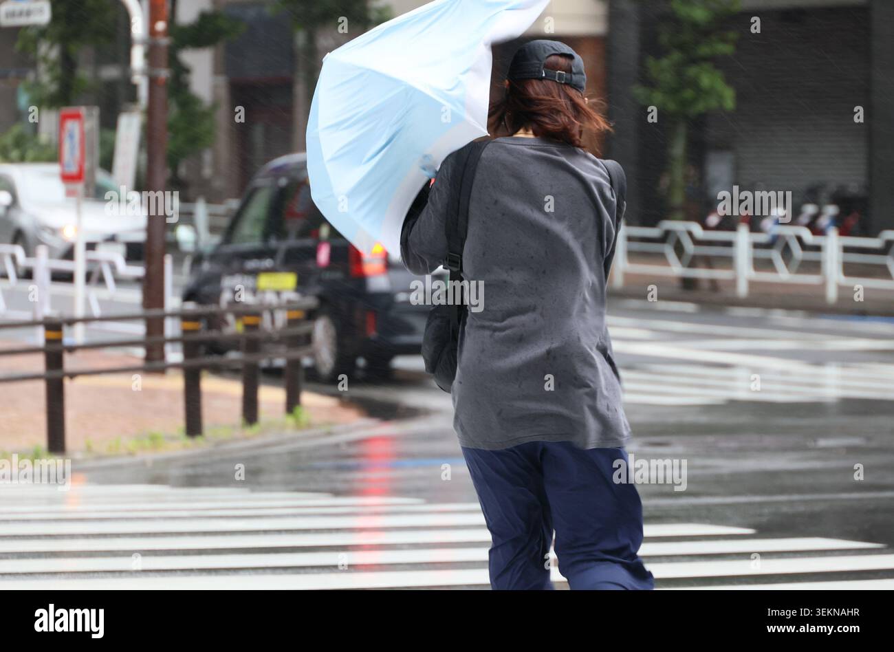 Tokyo, Japan. 3rd June, 2026. A man walks against strong wind and ...