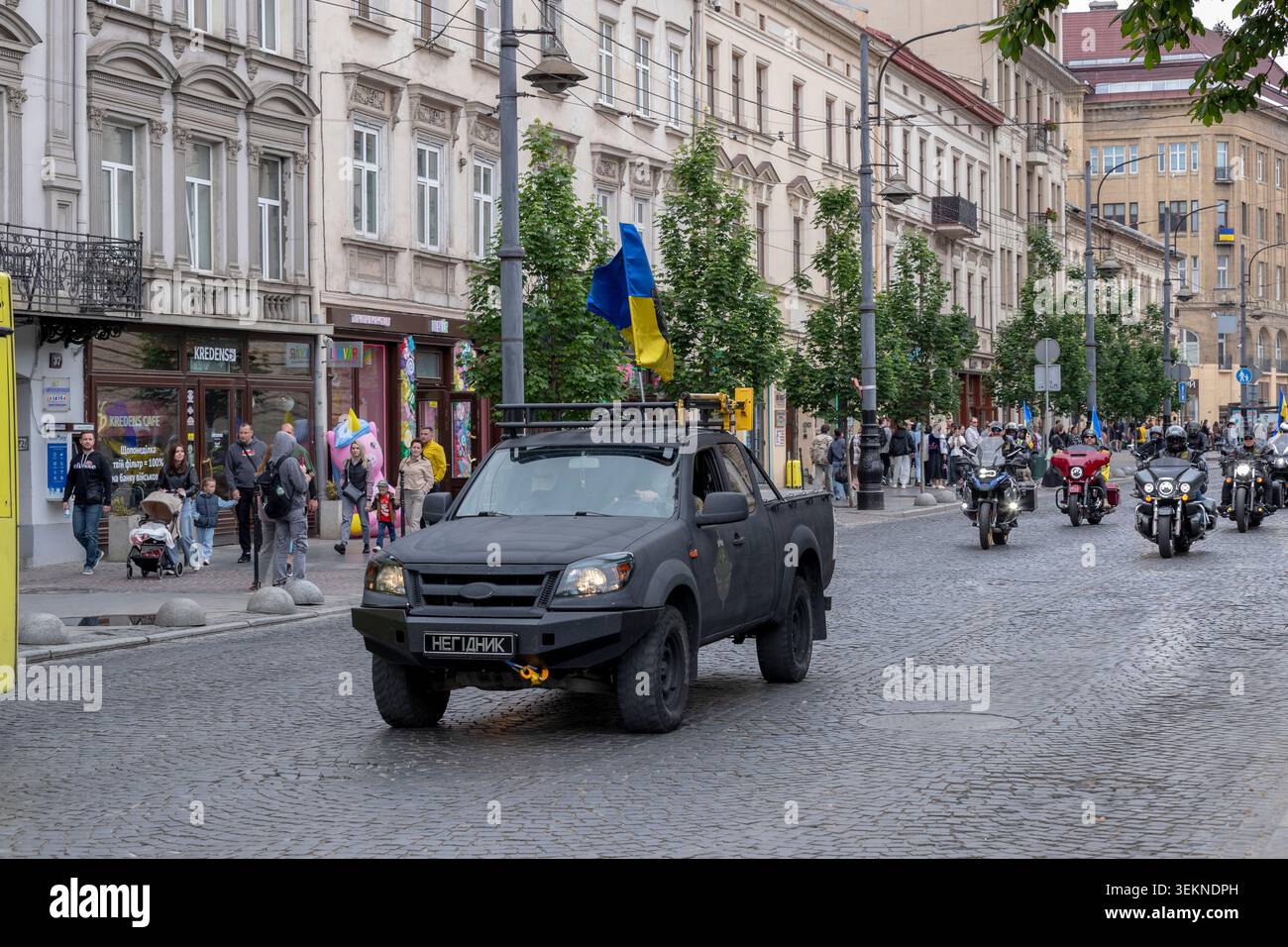 A vehicle displaying a Ukrainian flag travels through central Lviv ...