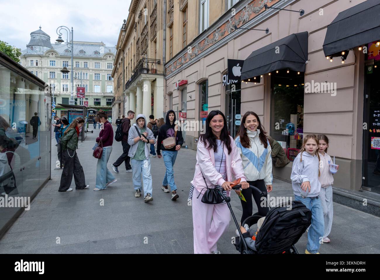 A woman pushes a pram along a pavement in central Lviv on Sunday, 31 ...