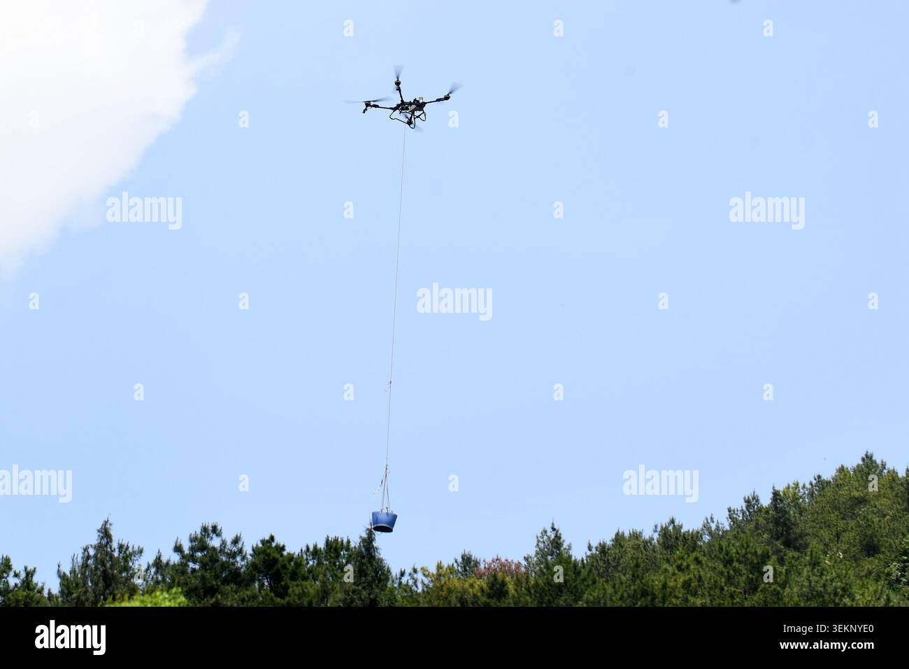 RENHUAI, CHINA - JUNE 3, 2026 - A drone is lifting construction ...