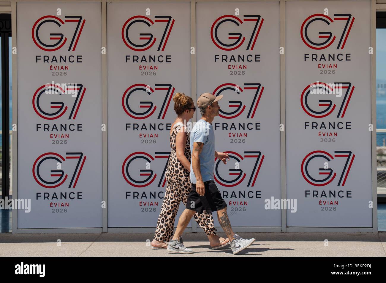 People walk past a G7 banner in Evian-les-Bains, eastern France ...