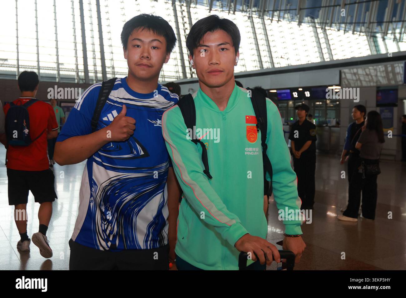 Shao Jiayi leads the Chinese men's football team as they depart from ...