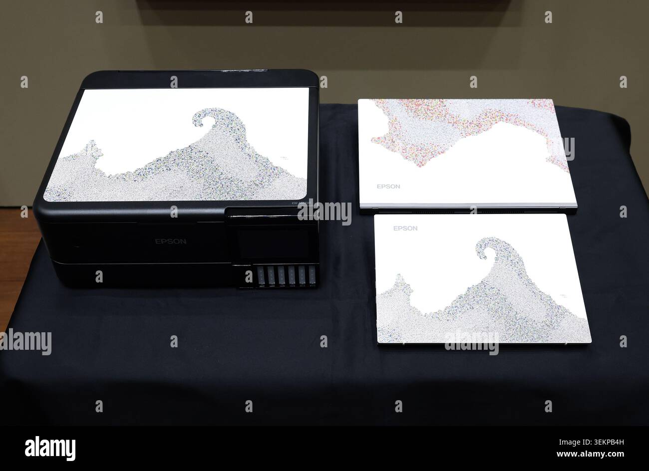 A photo shows a computer and printer adorned with artwork by Michito ...