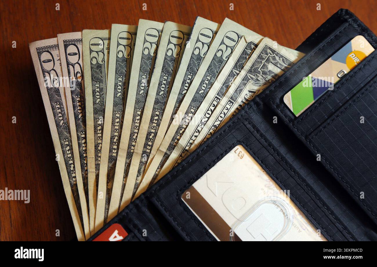 FILE - Cash is fanned out from a wallet in North Andover, Mass, June 15 ...