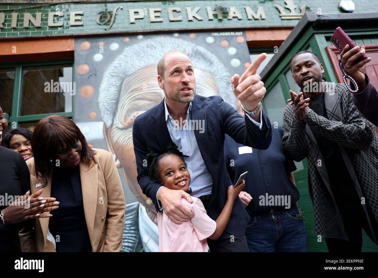 Britain's Prince William hugs a young girl during his visit to The ...