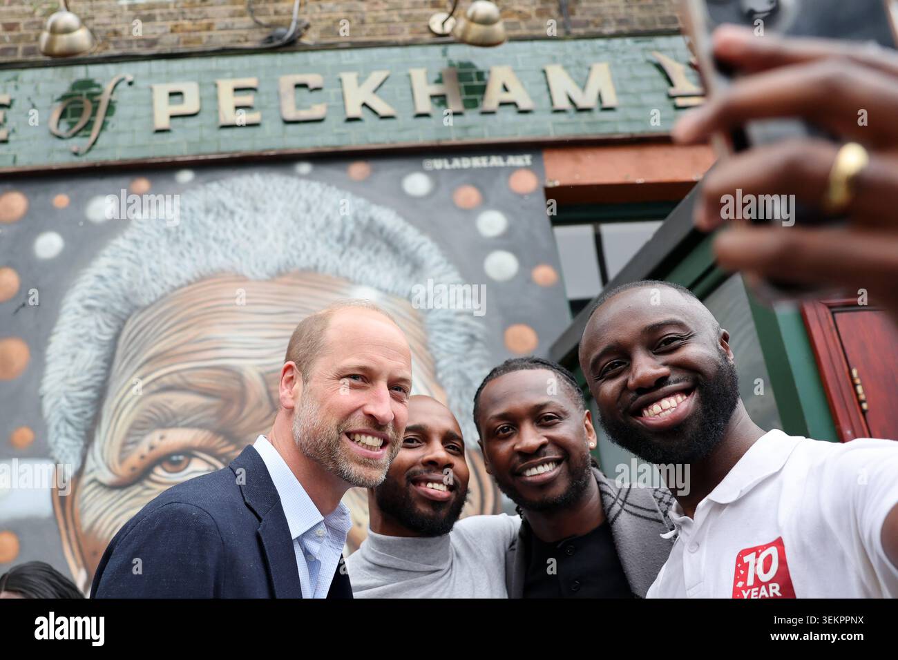 Britain's Prince William poses for a selfie with local residents during ...