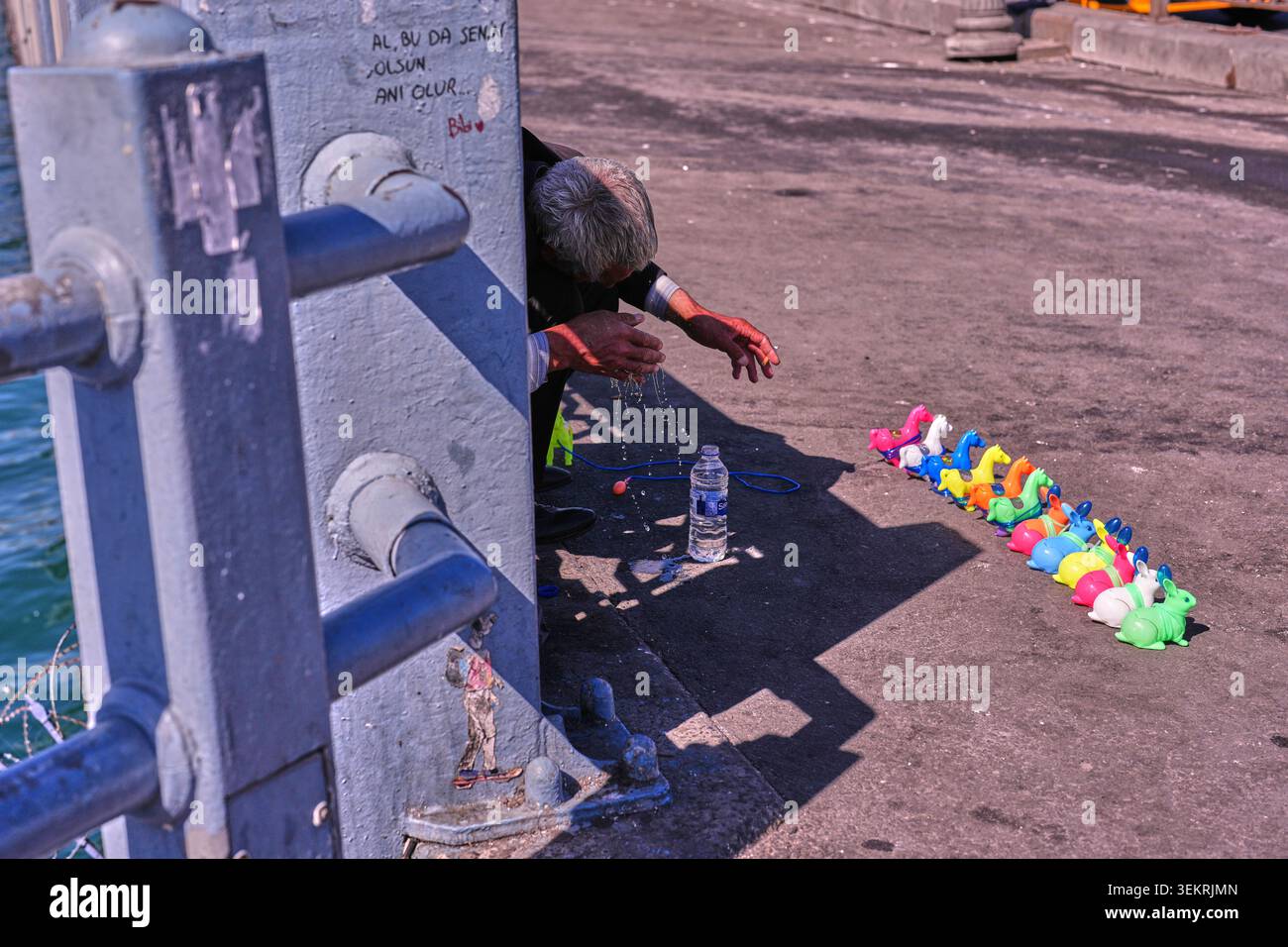 A street vendor cools off as he waits for customers on a hot day in ...