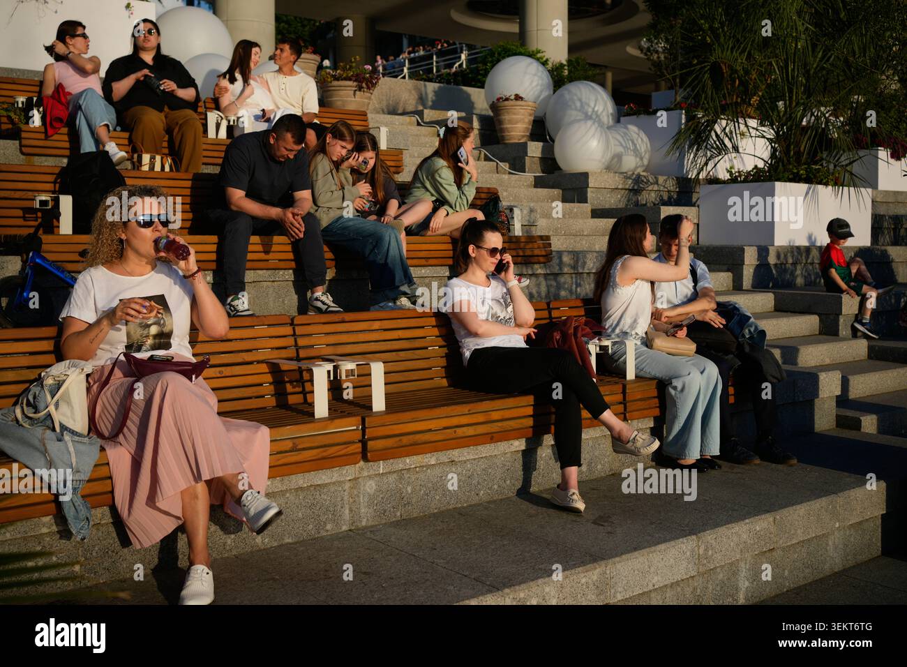 People enjoy a warm weather at Gorky park in Moscow, Wednesday, June 3 ...